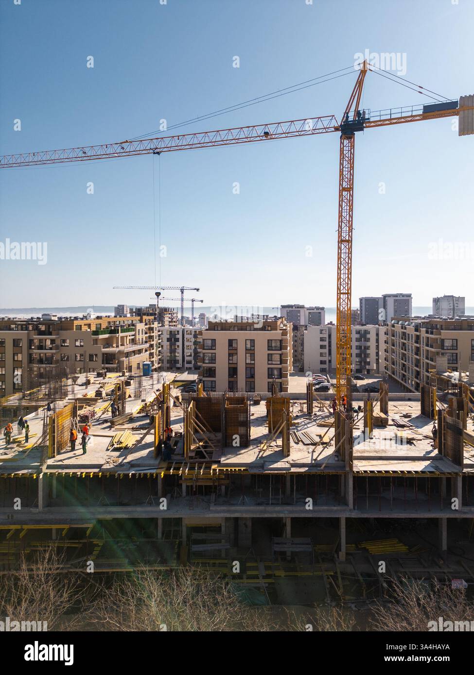 Aerial view of a cityscape with ongoing construction projects and completed residential ...