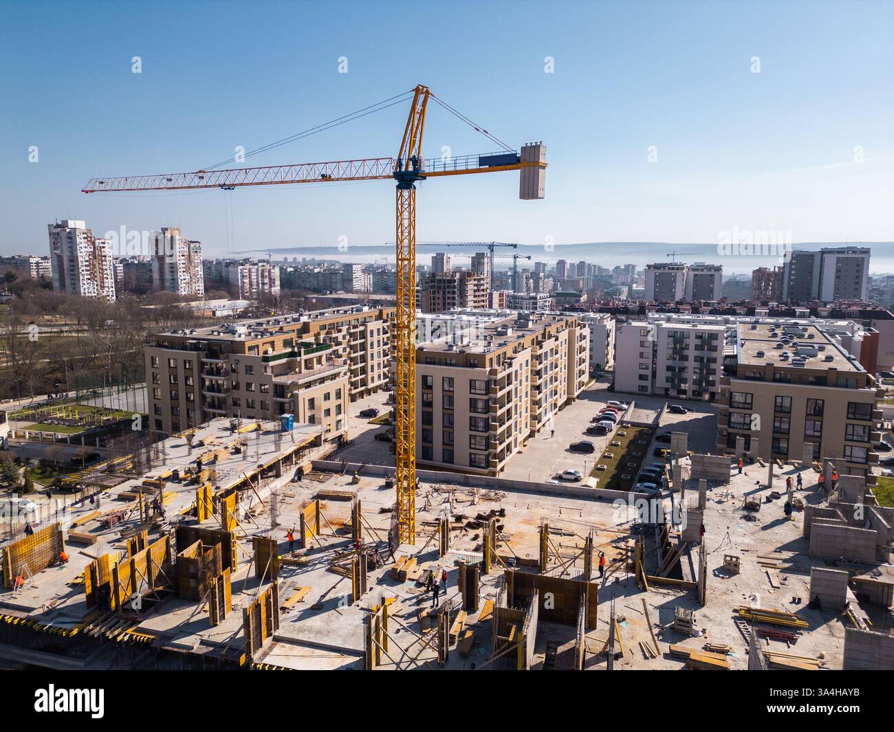 Aerial view of a cityscape with ongoing construction projects and completed residential ...