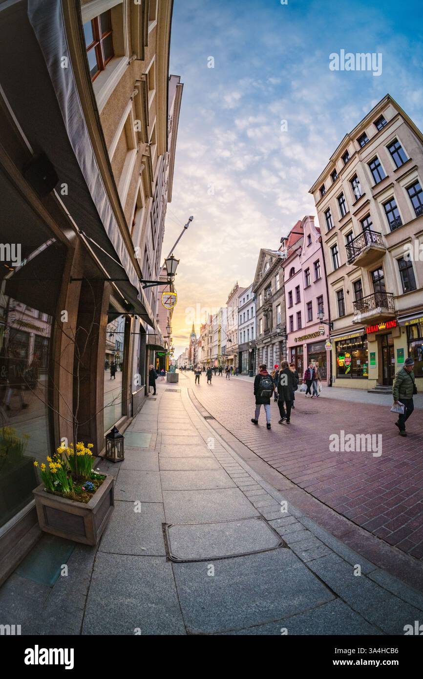 Visitors meander along Szeroka street in Torun, lined with historical ...