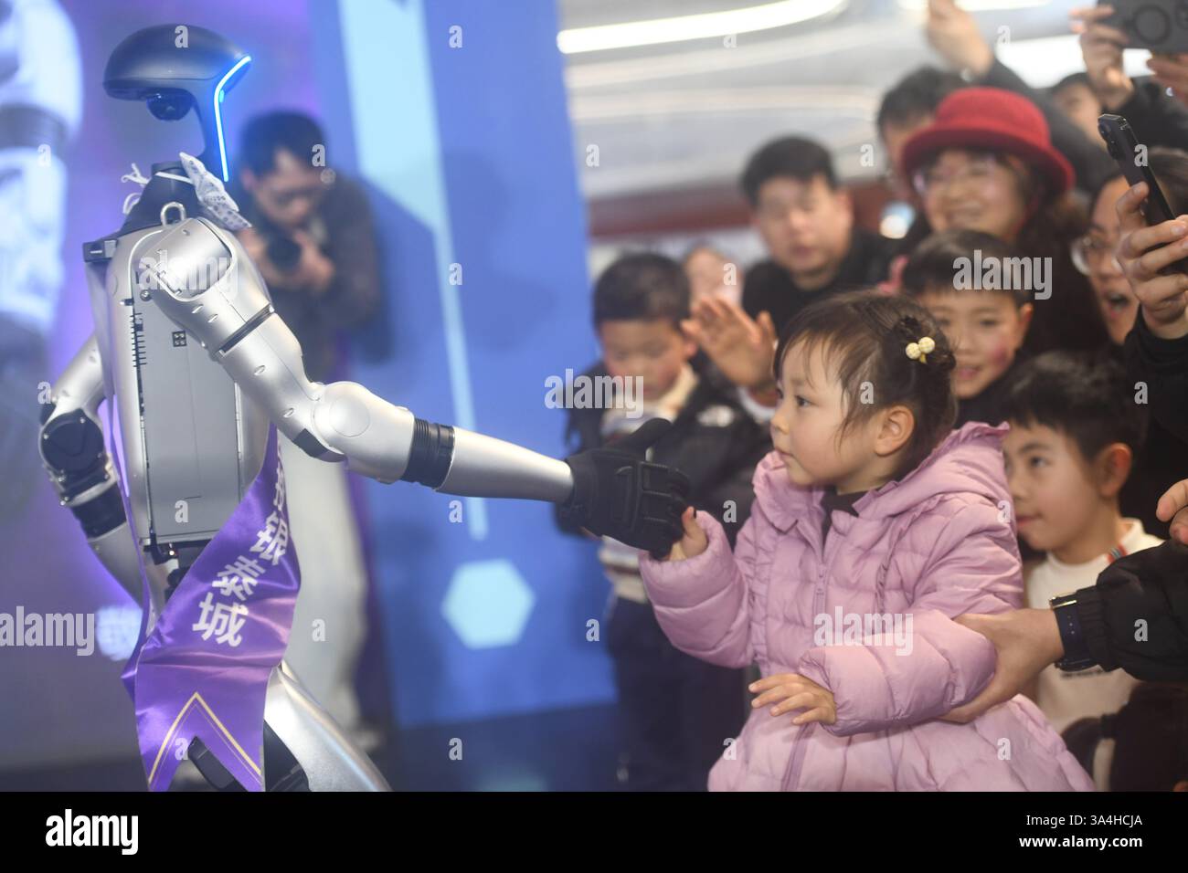 A humanoid robot performs in a shopping mall in Hangzhou City, east ...