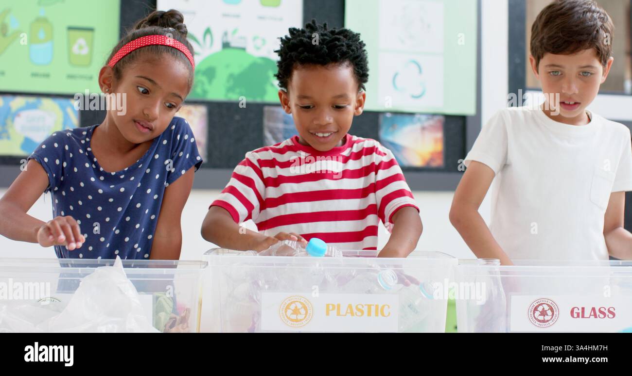 In school, children sorting plastic bottles into recycling bins ...
