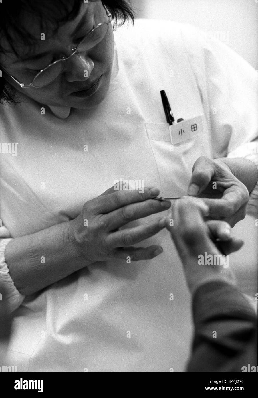 Feb 01, 2003; Oshima Island, JAPAN; Taking care of Mr Nambu's hands ...