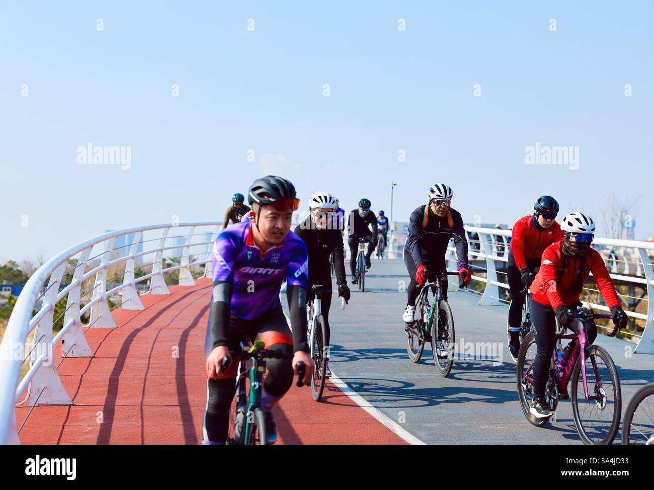 Cycling enthusiasts compete in a cycling race in Rizhao City, east ...