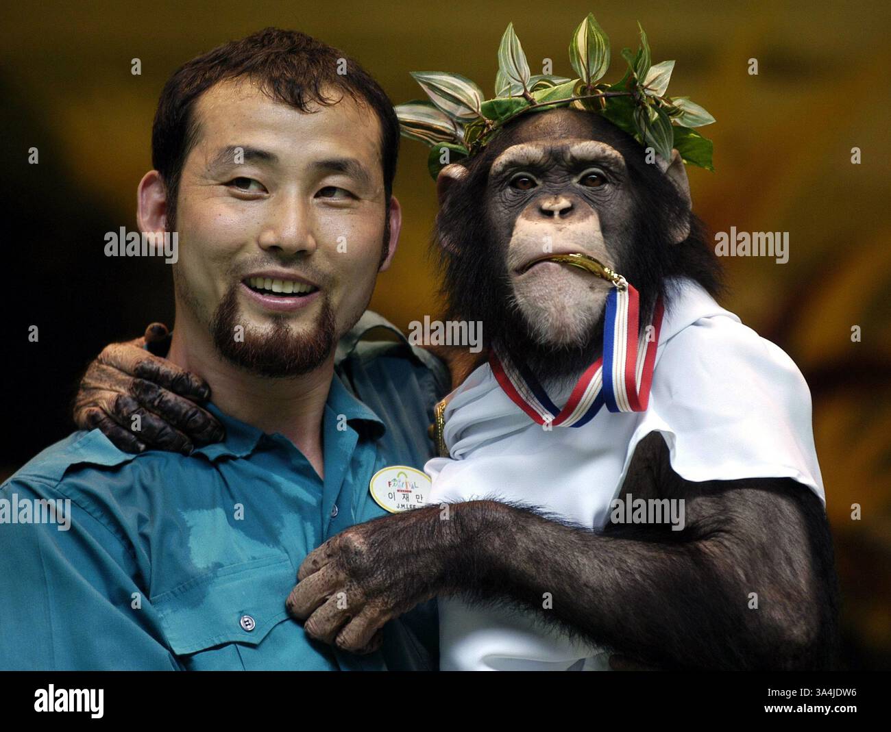 Aug 10, 2004; Yongin, SOUTH KOREA; A monkey and trainer pose for the ...