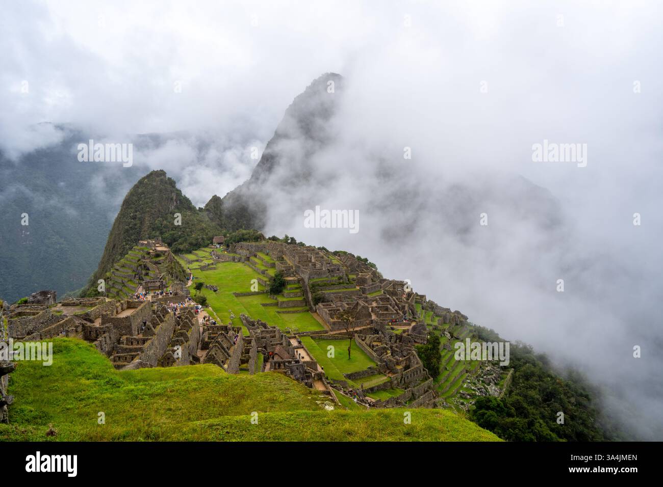 Machu Picchu, the famous Inca citadel in Peru, is nestled among mist ...