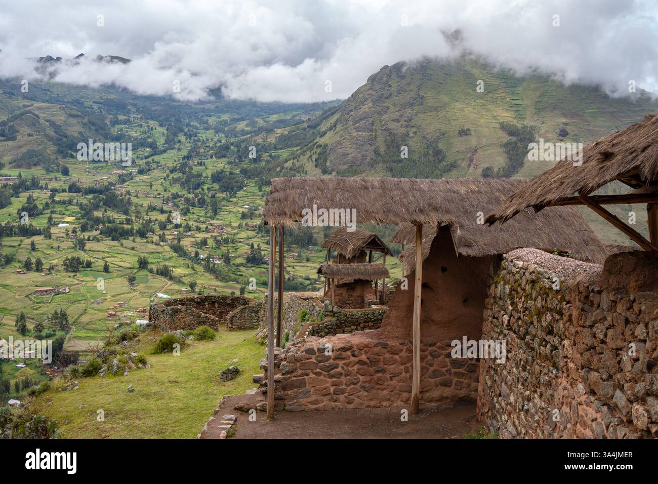 The Inca archaeological site of Pisac sits atop a lush green valley ...