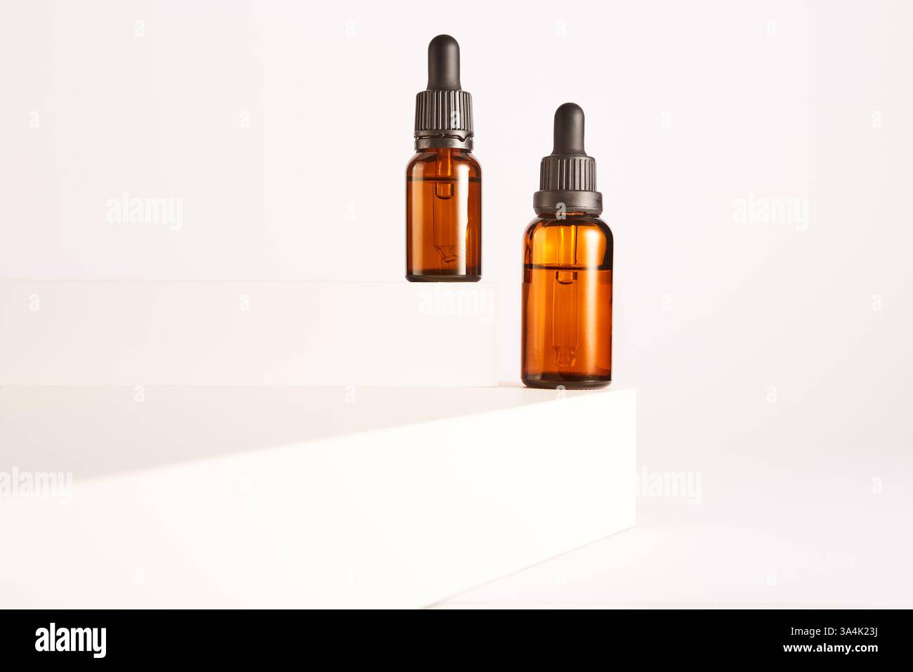 Dropper containers with pipettes on white background Stock Photo - Alamy