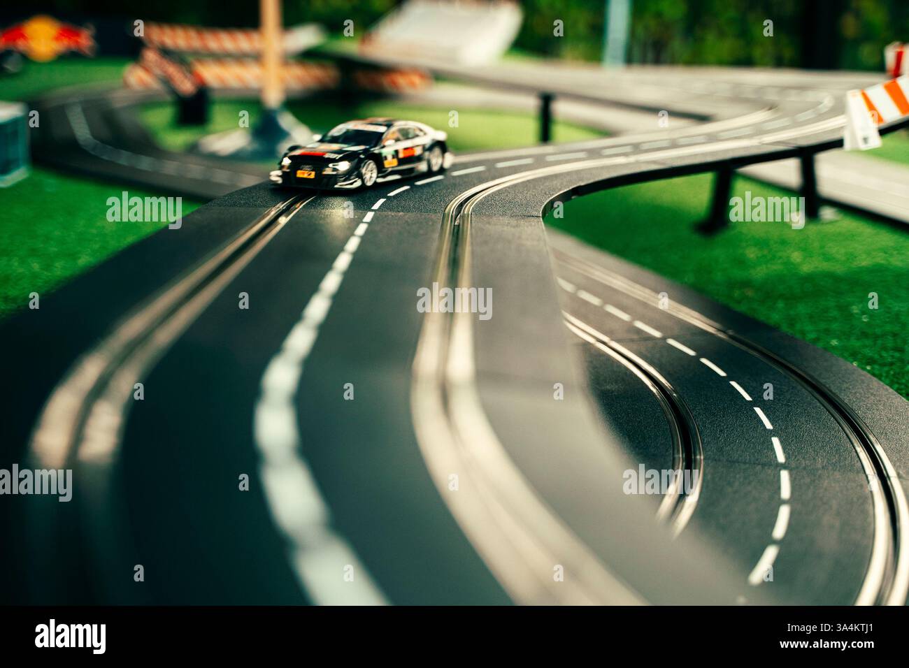 Miniature race car navigates a winding toy track, showcasing a detailed ...