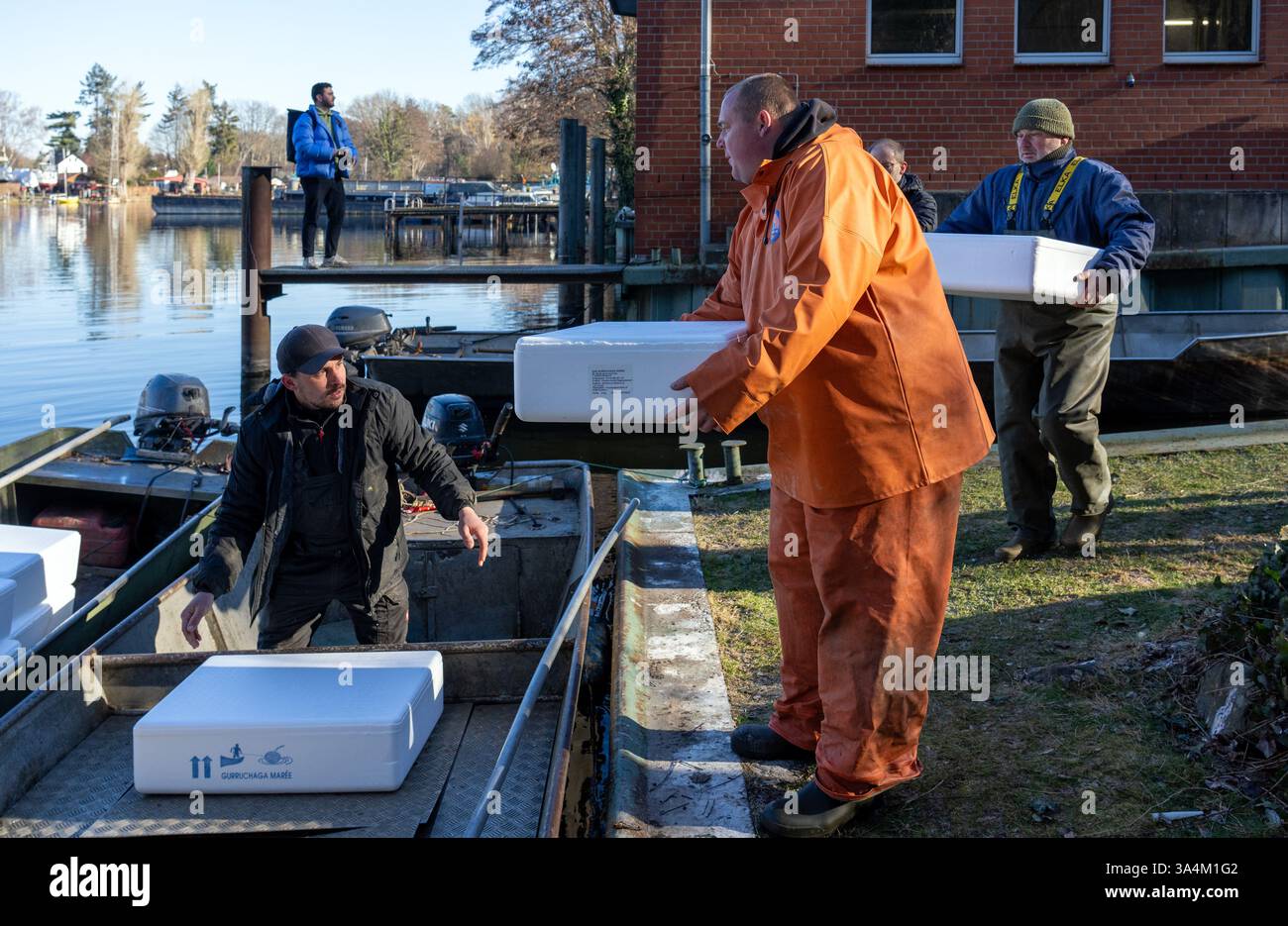 19 March 2025, Berlin: Spandau fisherman Jens Hidde (M) and his ...