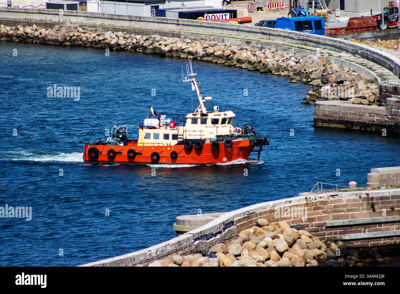 SKAGEN, DENMARK - JUNE 1, 2023 orange tug leaving harbour Stock Photo ...