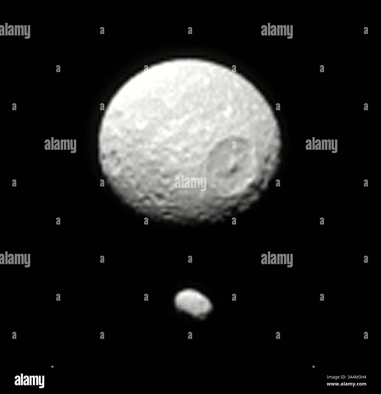 May 14, 2013 - Detail) Saturn moons Mimas (at top) and Pandora in a ...
