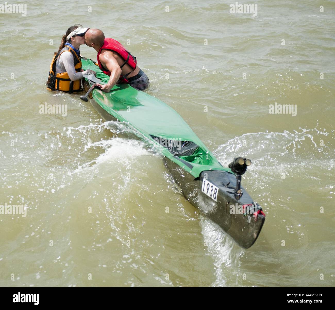 June 17, 2014 - Seadrift, Texas, USA - Paddlers kiss in the waves of ...