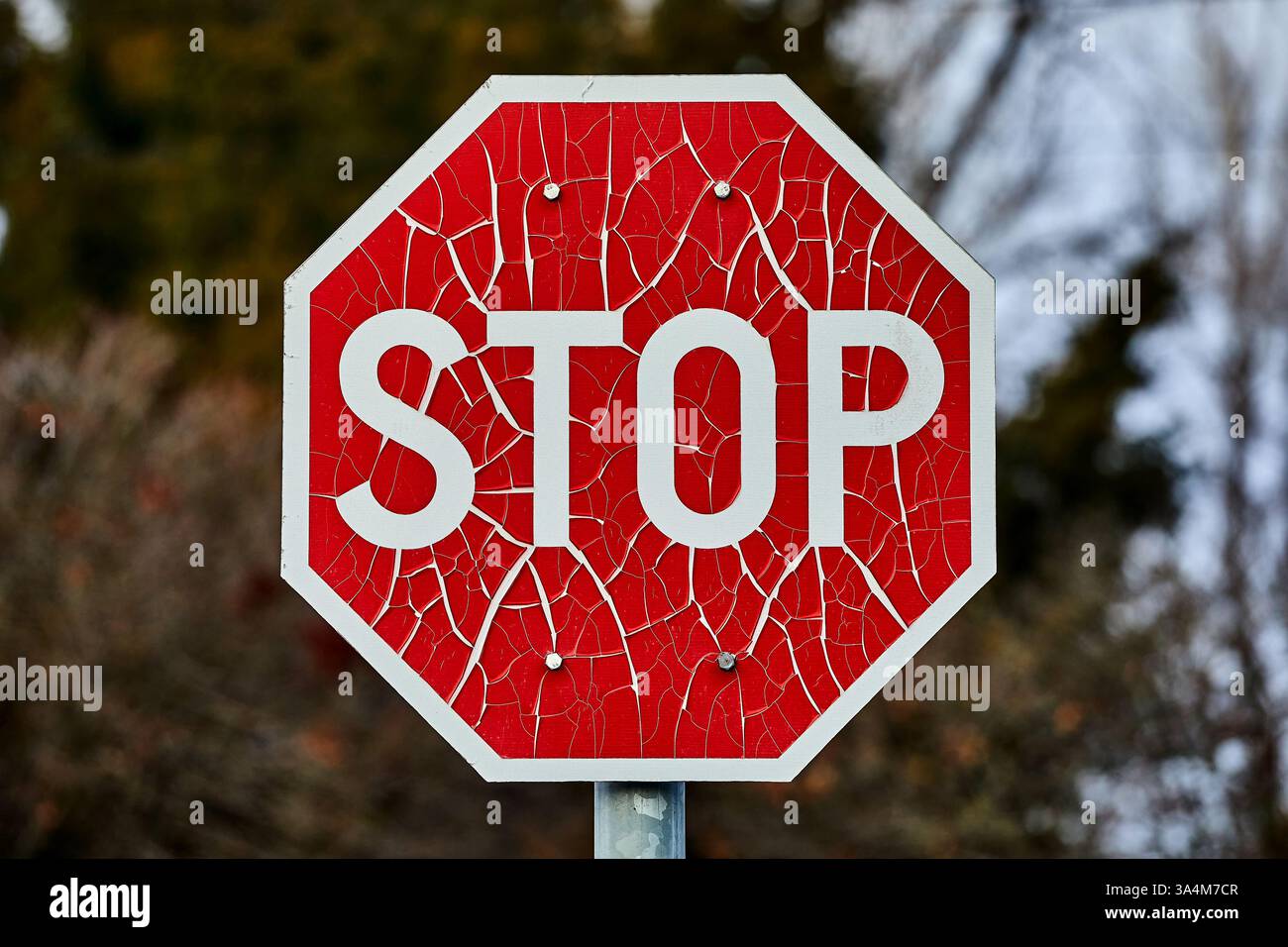Stop sign with broken paint peeling Stock Photo - Alamy
