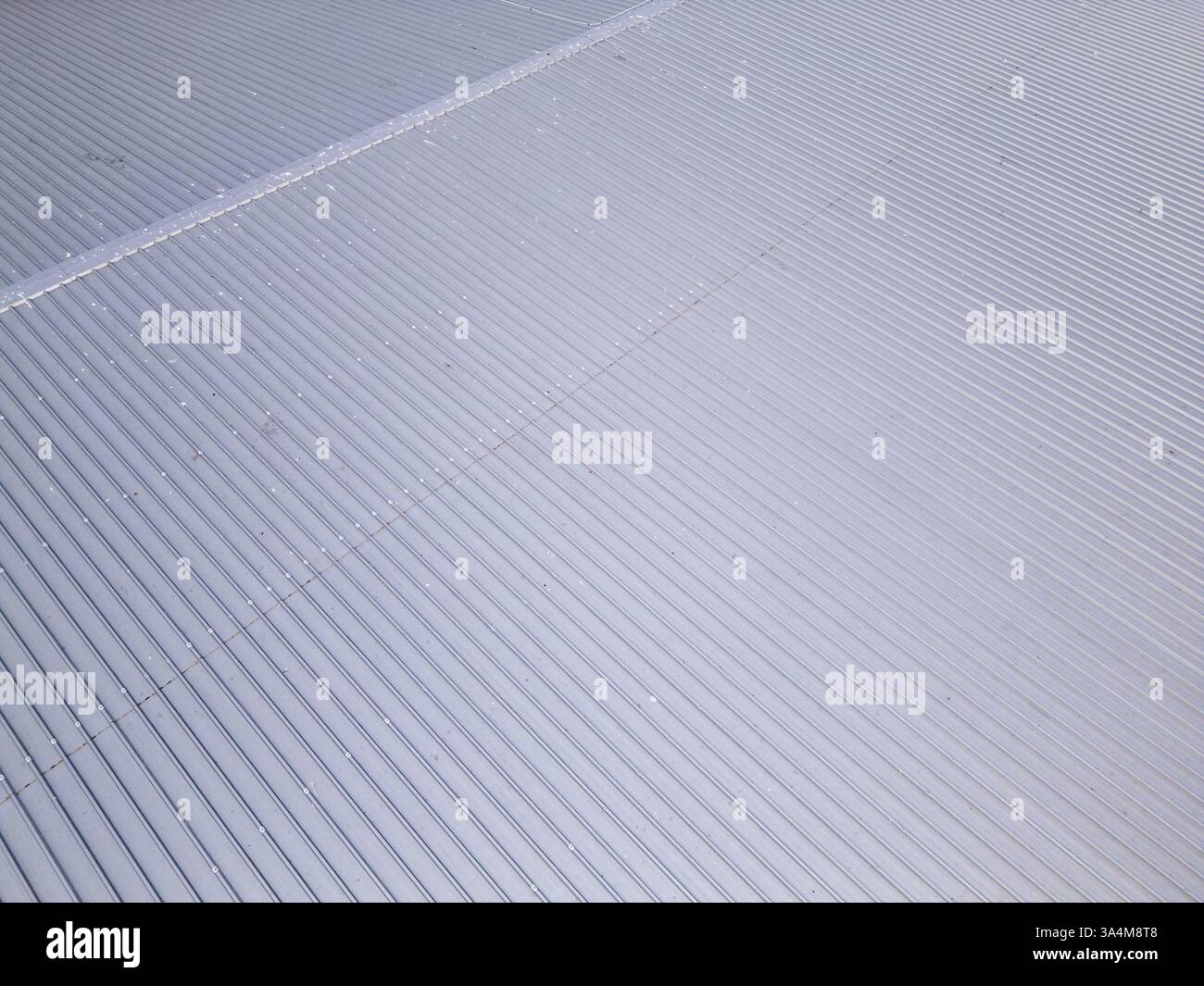Metallic corrugated sheet roof with linear patterns. Industrial and ...