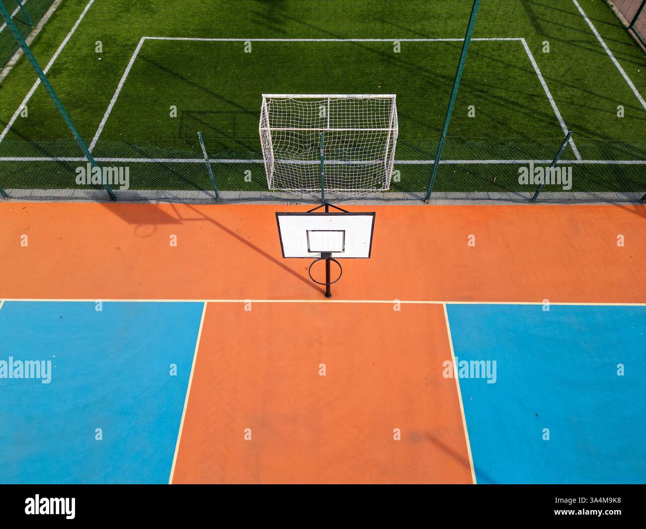 Aerial view of outdoor basketball and soccer courts with vibrant blue ...