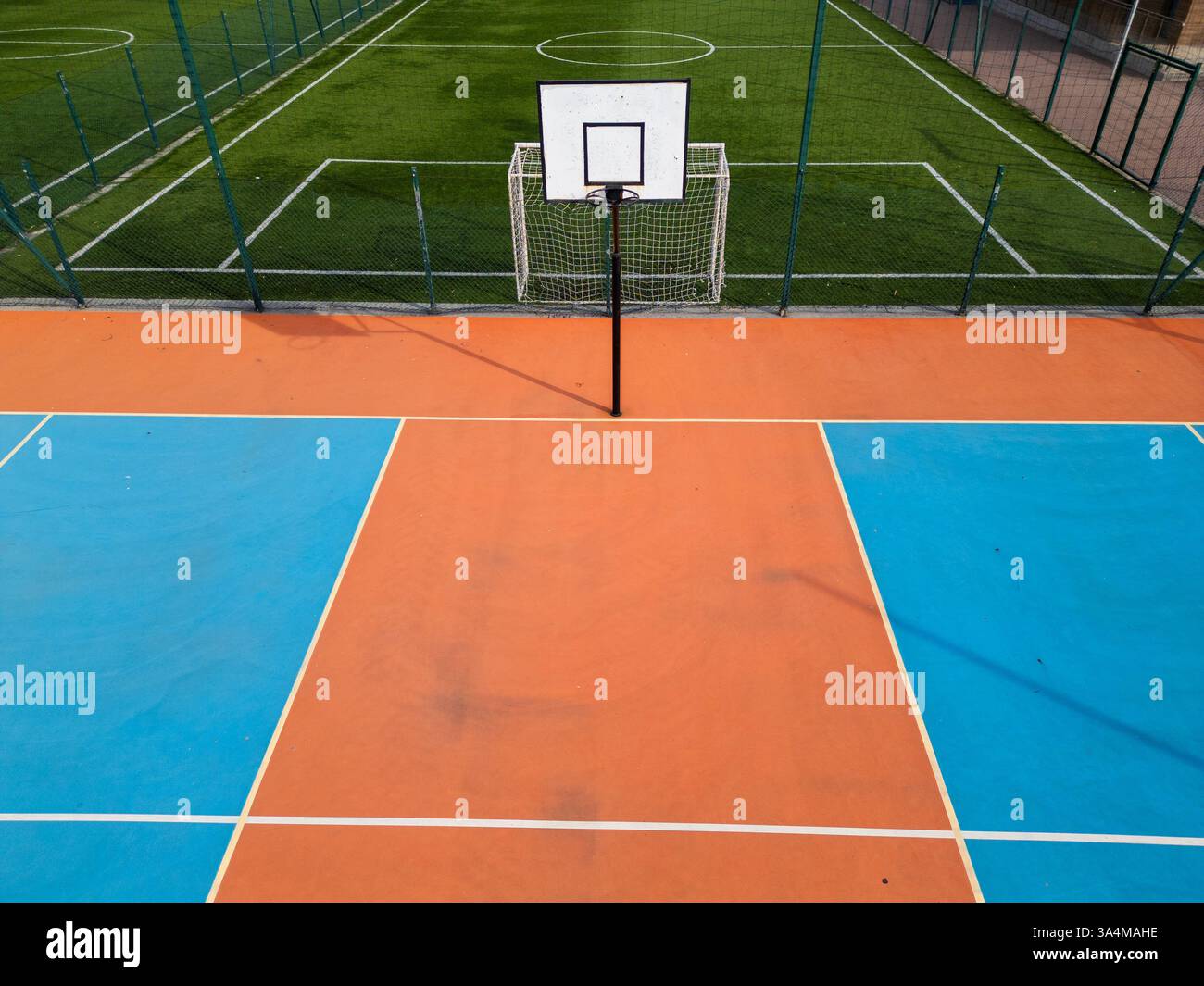 Aerial view of outdoor basketball and soccer courts with vibrant blue ...