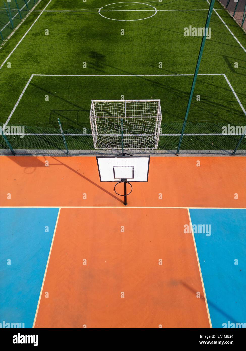 Aerial view of outdoor basketball and soccer courts with vibrant blue ...