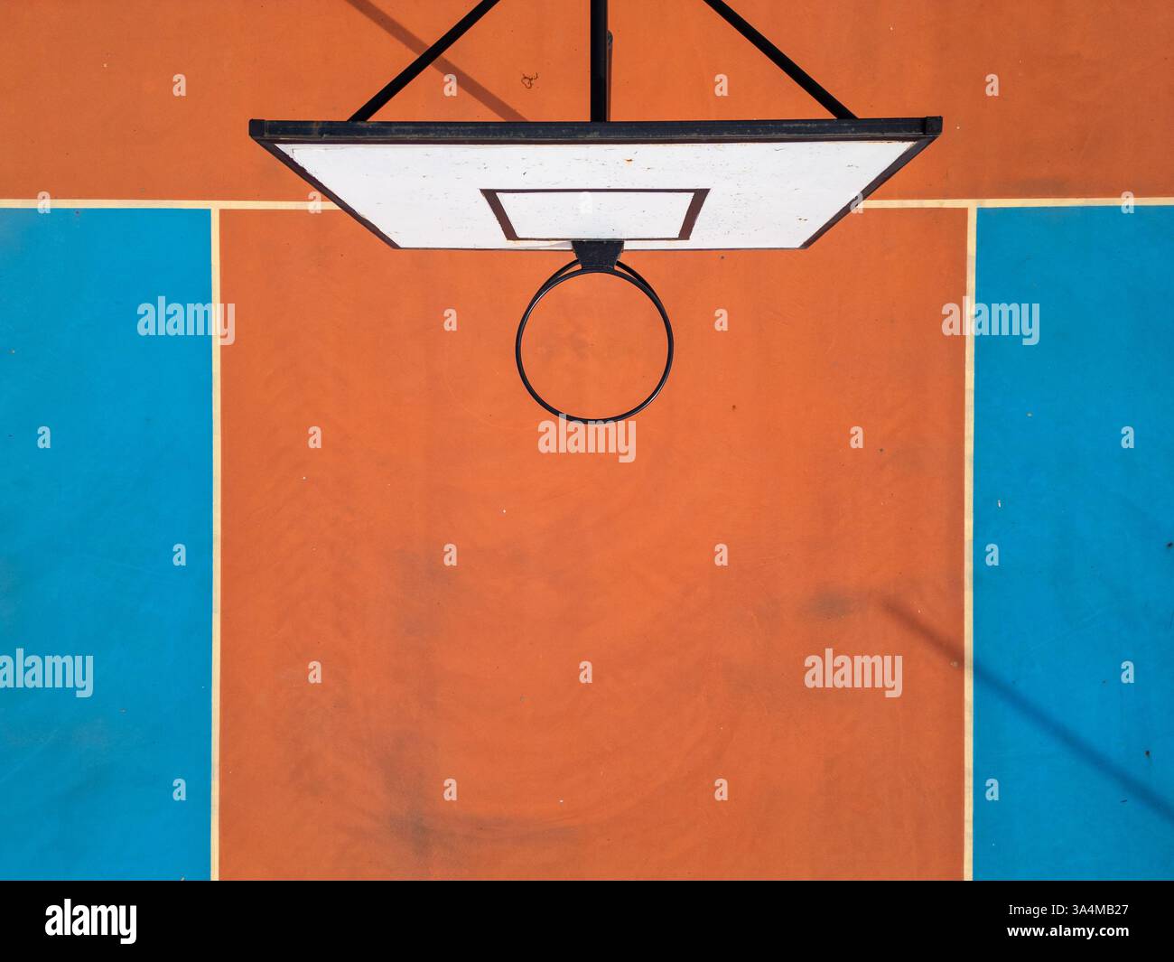 Aerial view of a basketball hoop and colorful court with vibrant orange ...