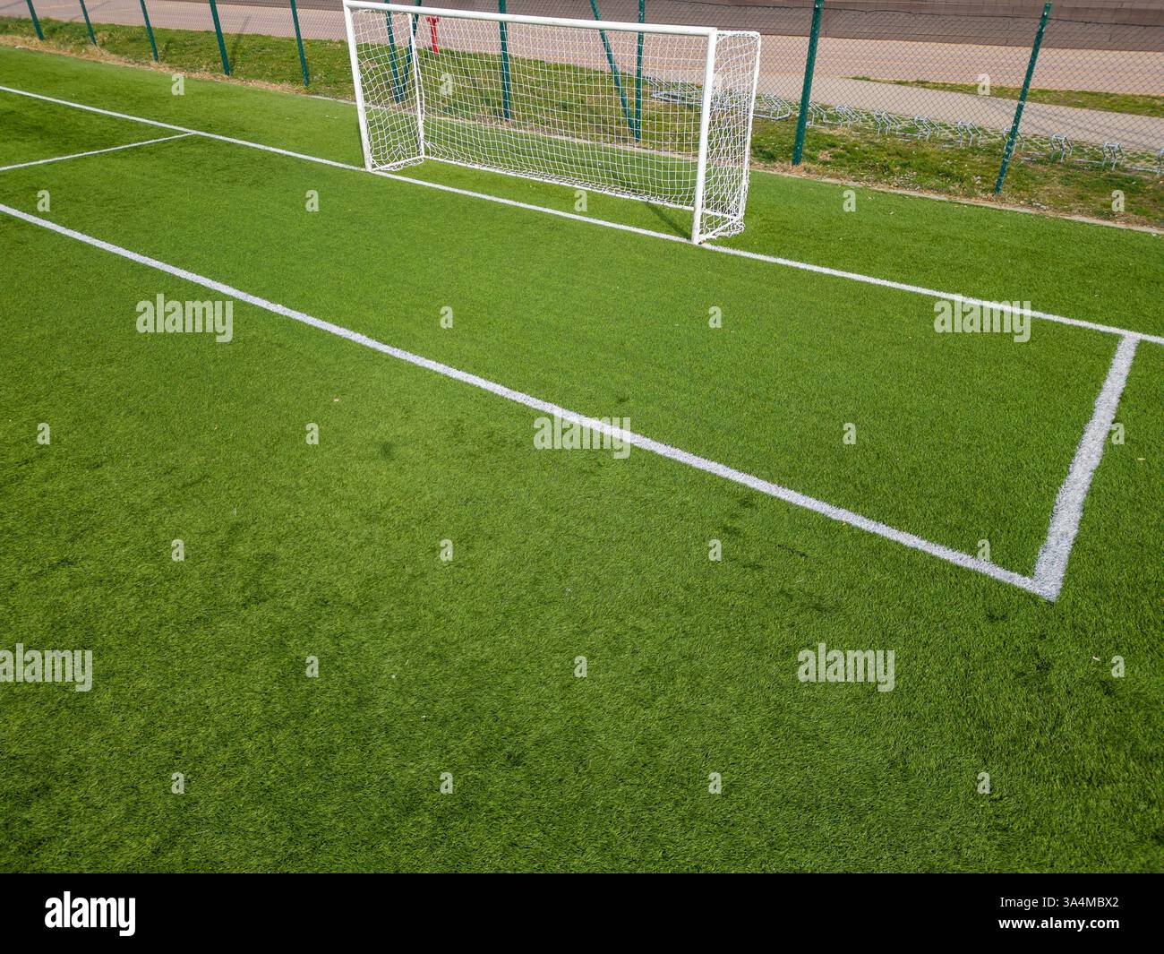 Aerial view of a soccer goal on a green artificial turf field with ...