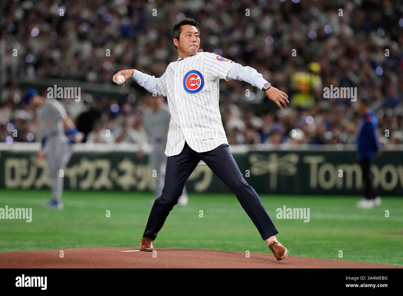 Former player Koji Uehara throws out a ceremonial first pitch before an MLB Tokyo Series ...