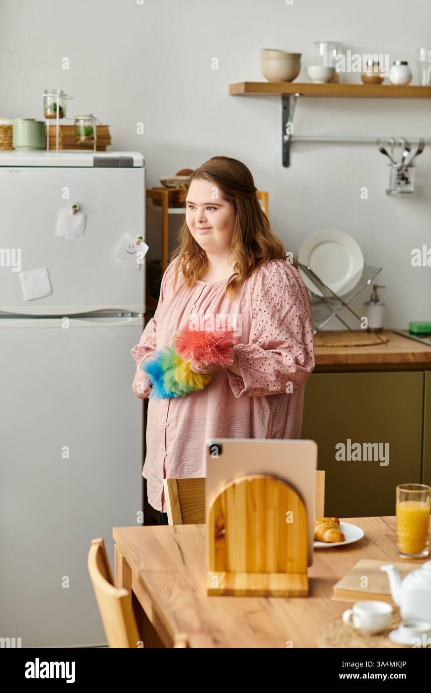 Pretty woman with Down syndrome enjoys her time cleaning and tidying ...
