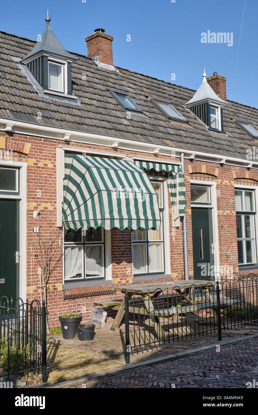 March 10, 2025 - Grou, Netherlands: A row of early 20th-century workers ...