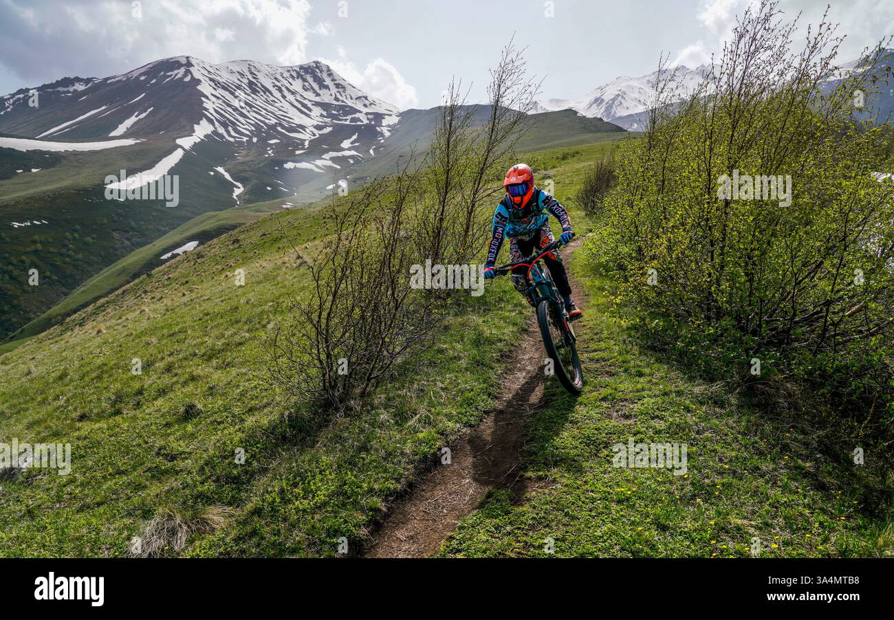 A mountain biker rides the trails in the Caucasus Mountains of Georgia ...