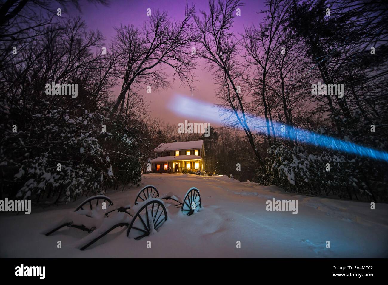 A warm New England home in a snowy forest setting Stock Photo - Alamy