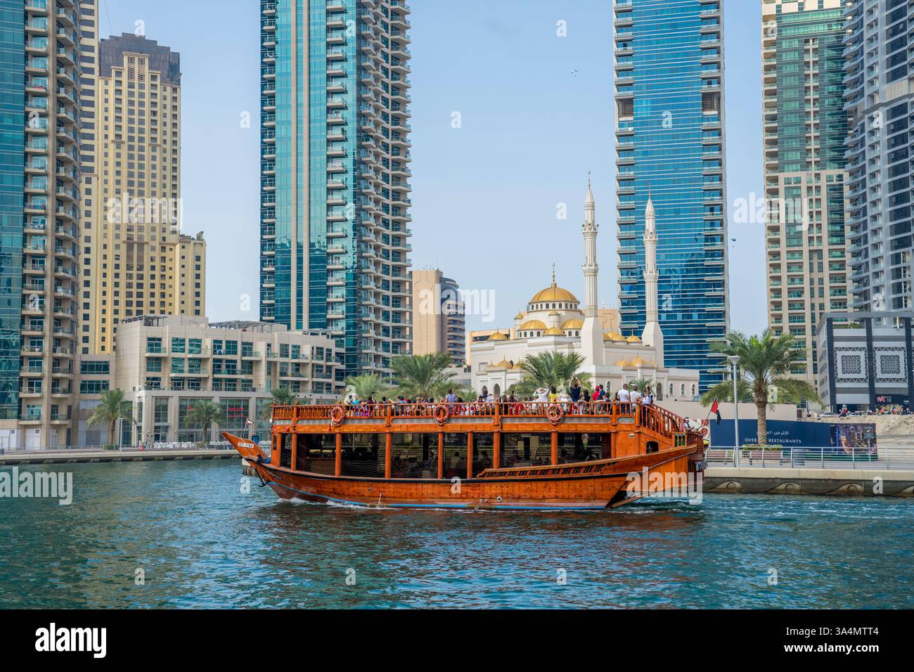 A traditional Arabic dhow contrasts the ancient and the modern in the ...