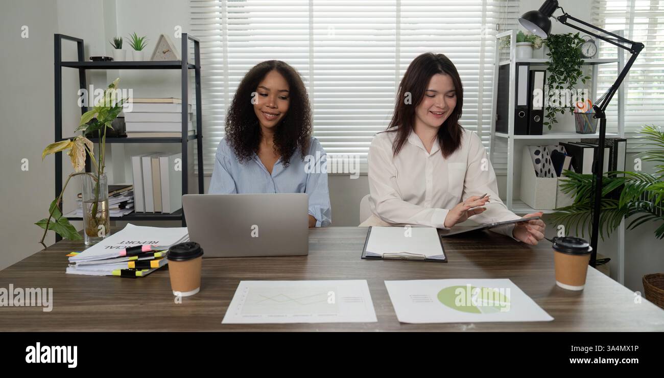 Collaboration and Creativity. Colleagues reviewing documents and ...