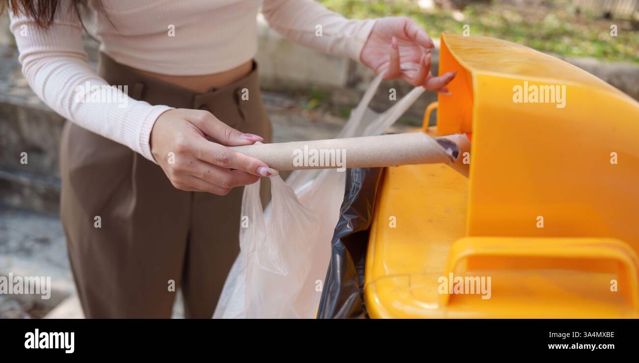 Waste Reduction and Recycling. A person inserting cardboard into a ...