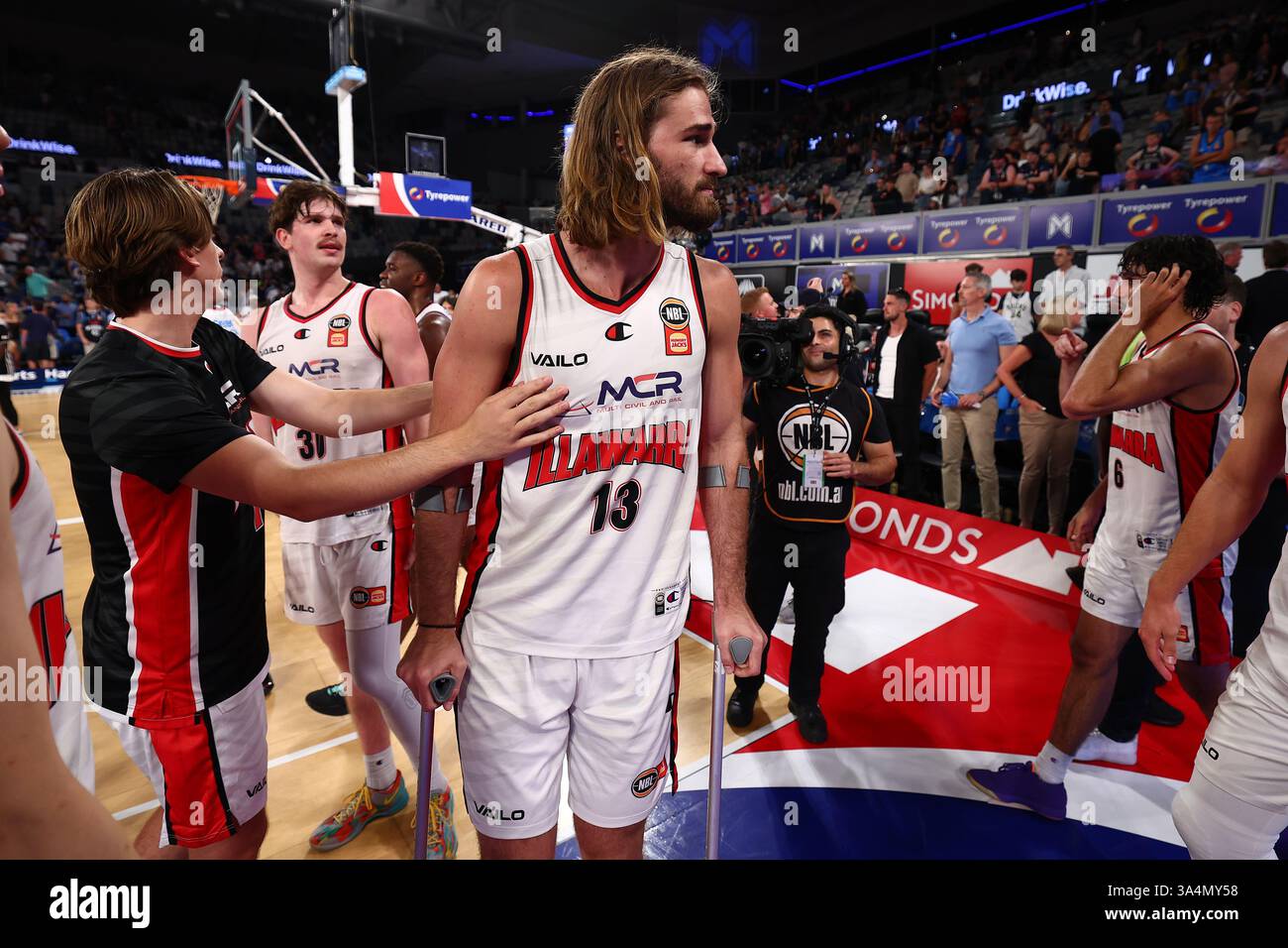 Hawks players and staff members rally around Sam Froling of the ...