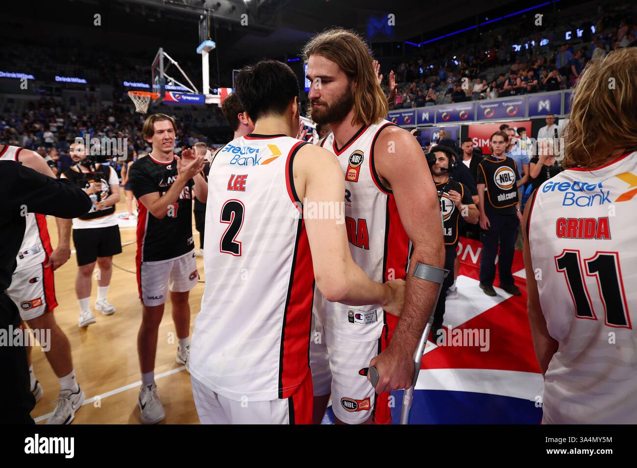 Hawks players and staff members rally around Sam Froling of the ...