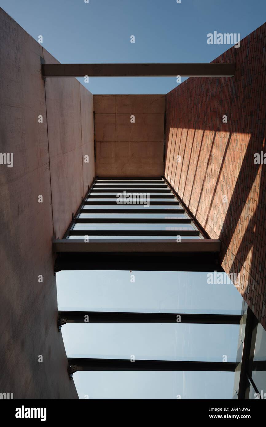 A modern architectural structure showcasing a sleek glass roof ...