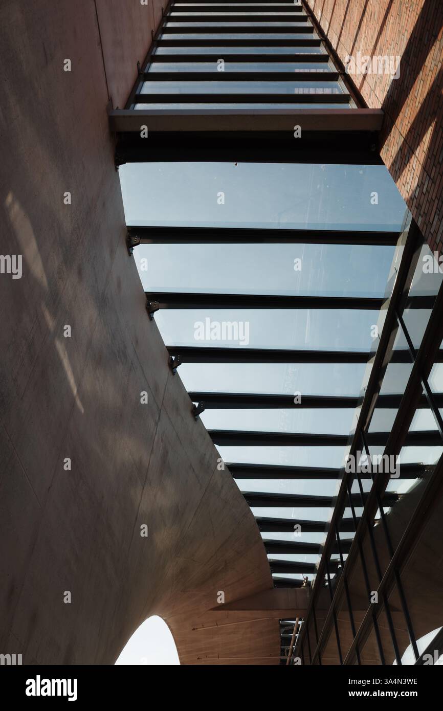 A modern architectural structure showcasing a sleek glass roof ...