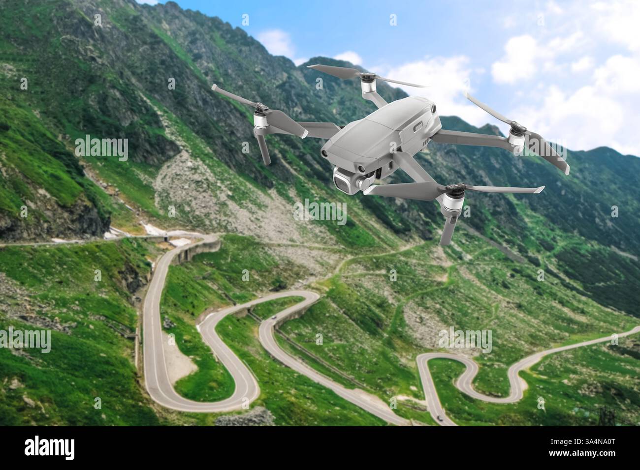 Drone with camera flying in mountains. Unmanned aerial vehicle for ...