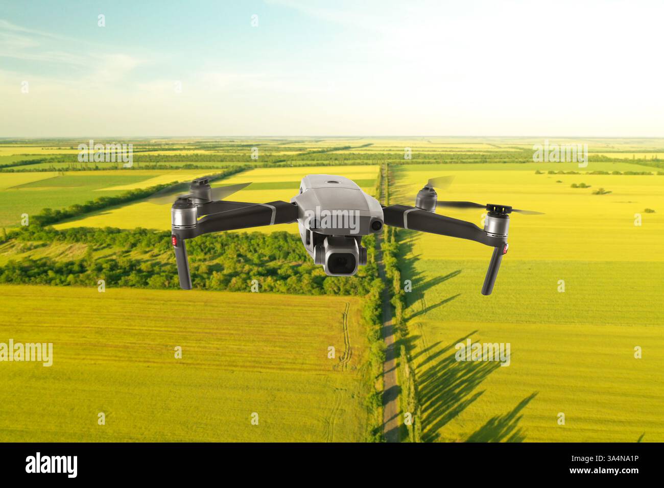 Drone with camera flying over fields. Unmanned aerial vehicle for ...