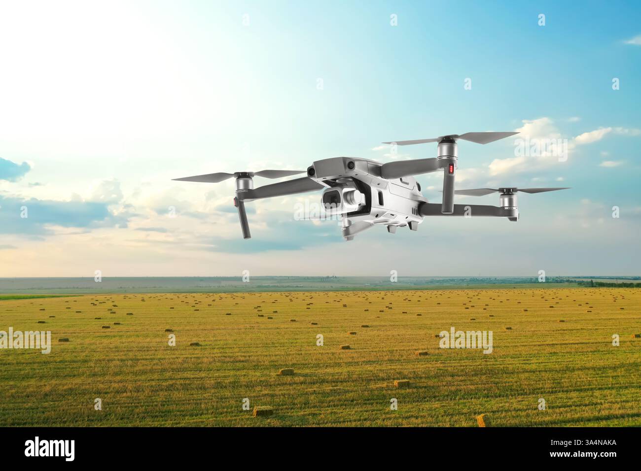 Drone with camera flying over fields. Unmanned aerial vehicle for ...