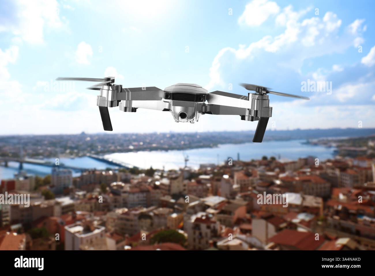 Drone with camera flying over city. Unmanned aerial vehicle for ...