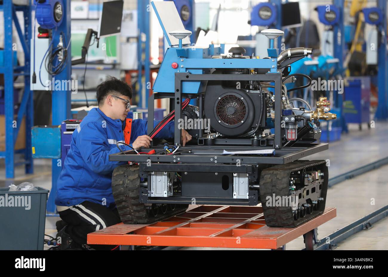 HUAI'AN, CHINA - MARCH 19, 2025 - A worker assembles an Orchard ...