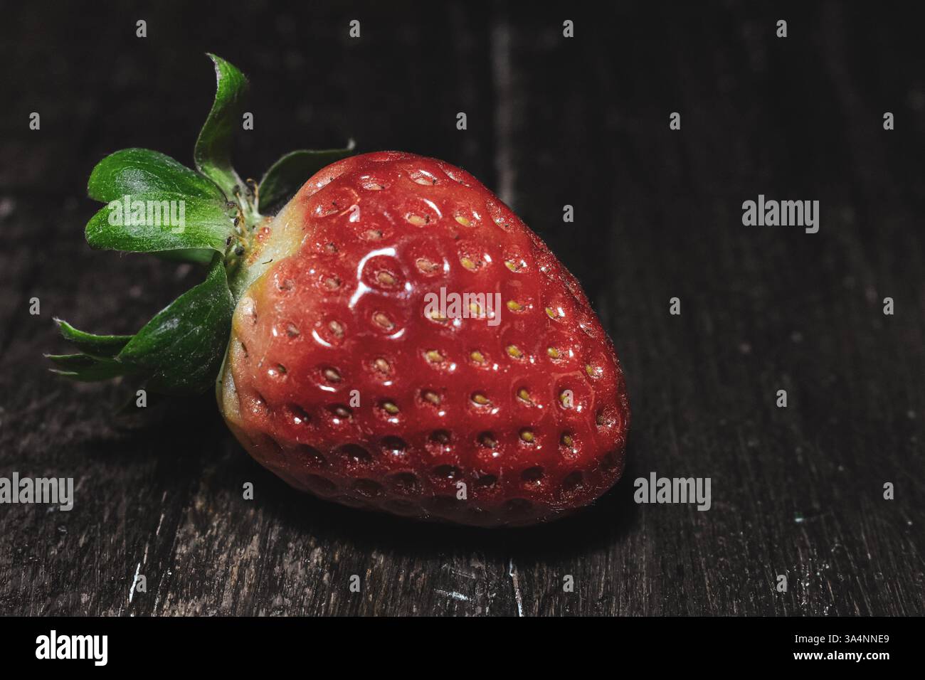 A single strawberry Background Stock Photo - Alamy