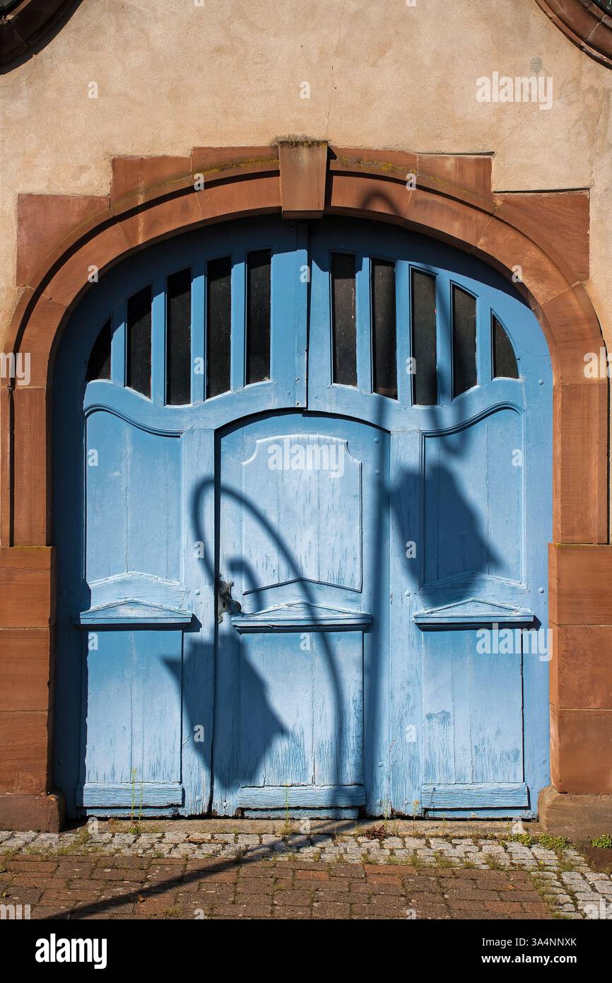 Saint-Quirin, old blue wooden gate with shadows from street lamps Stock ...