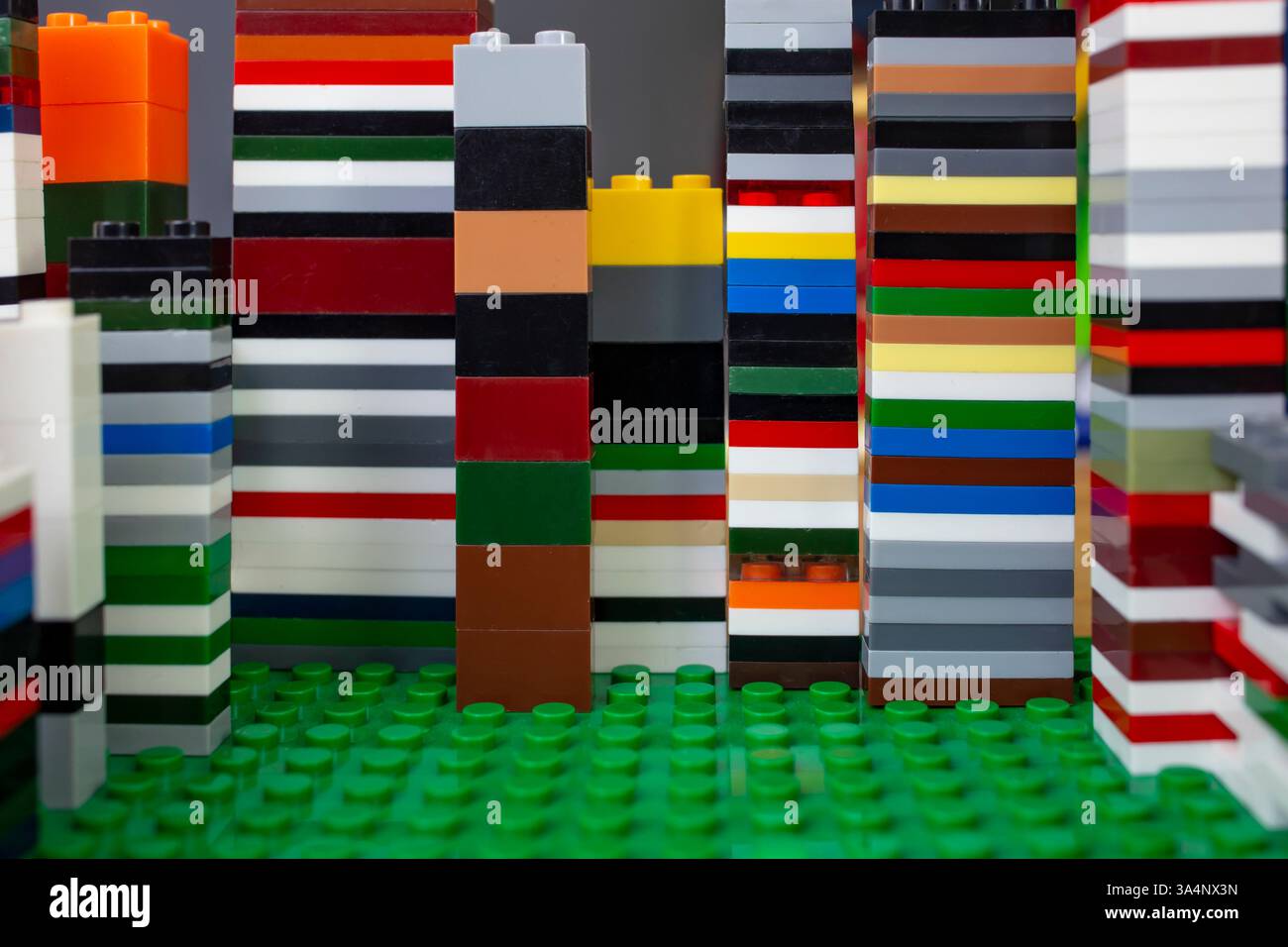 Tall building blocks towers background on green desk , abstract ...