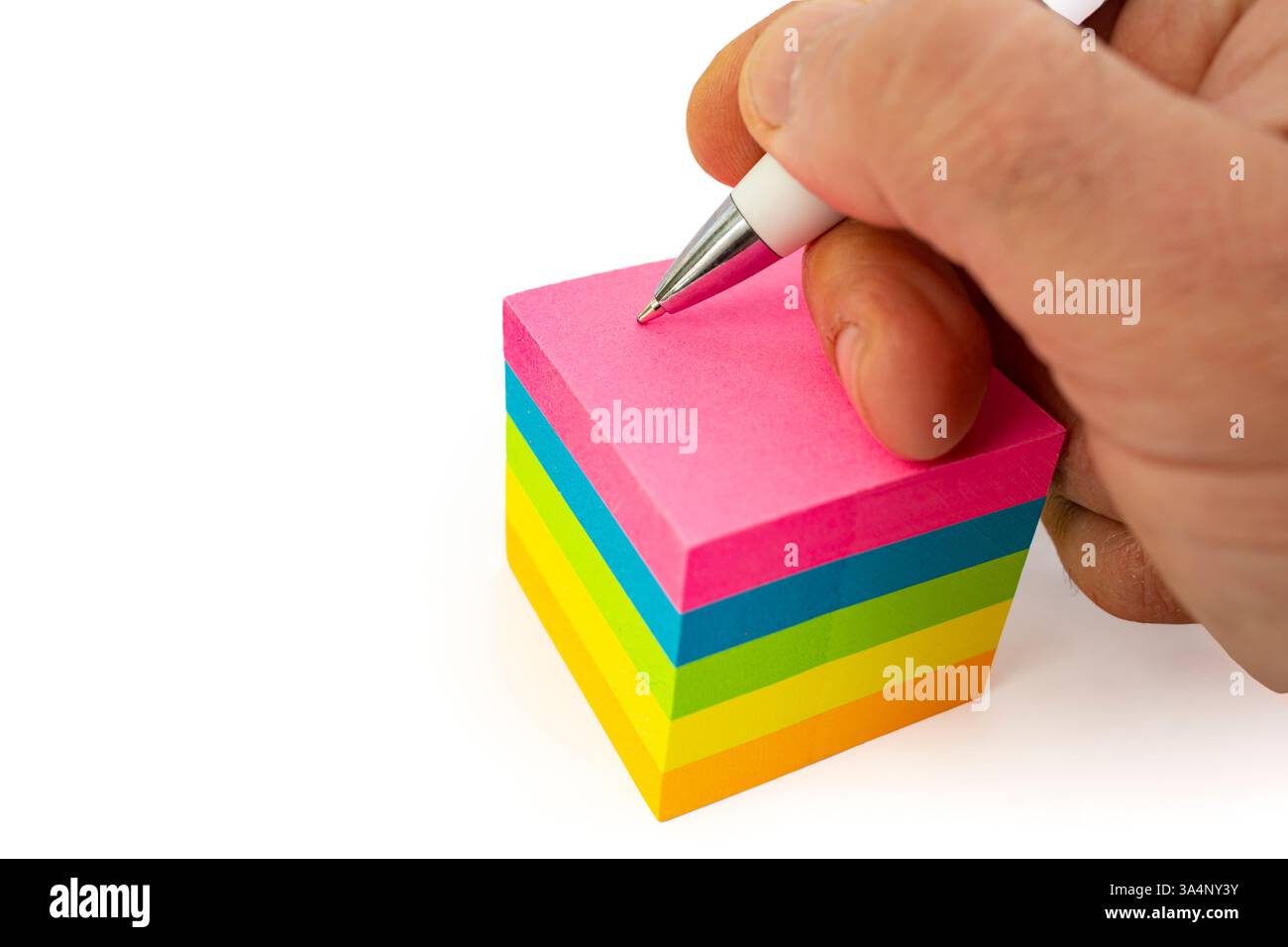 Colorful sticky note stack with a hand holding a roller ball pen , with ...