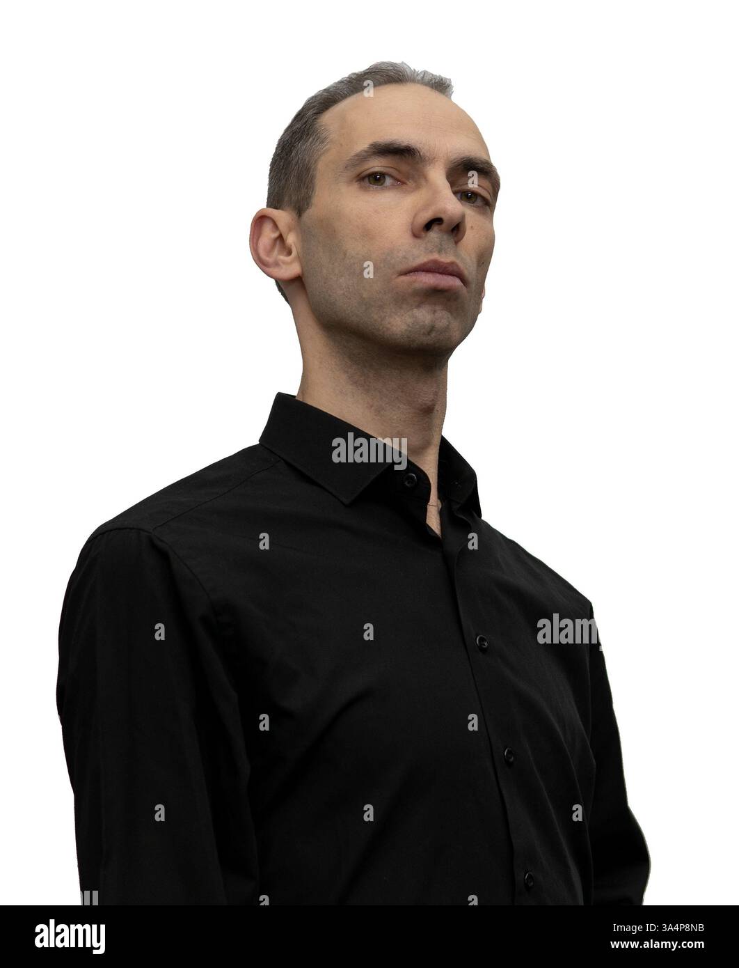 A middle-aged man in a black shirt looks down with an important and ...