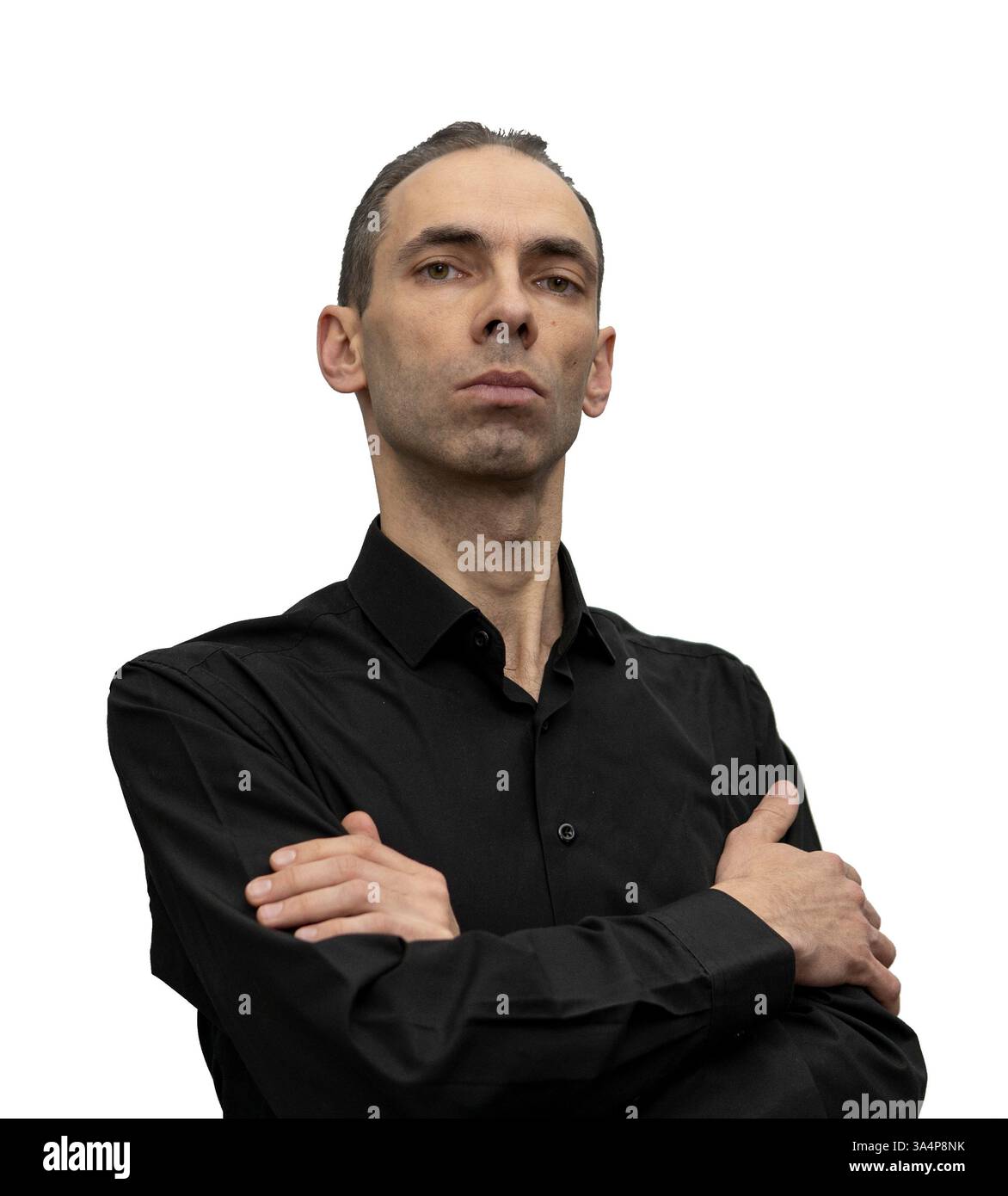 A middle-aged man in a black shirt looks down with an important and ...