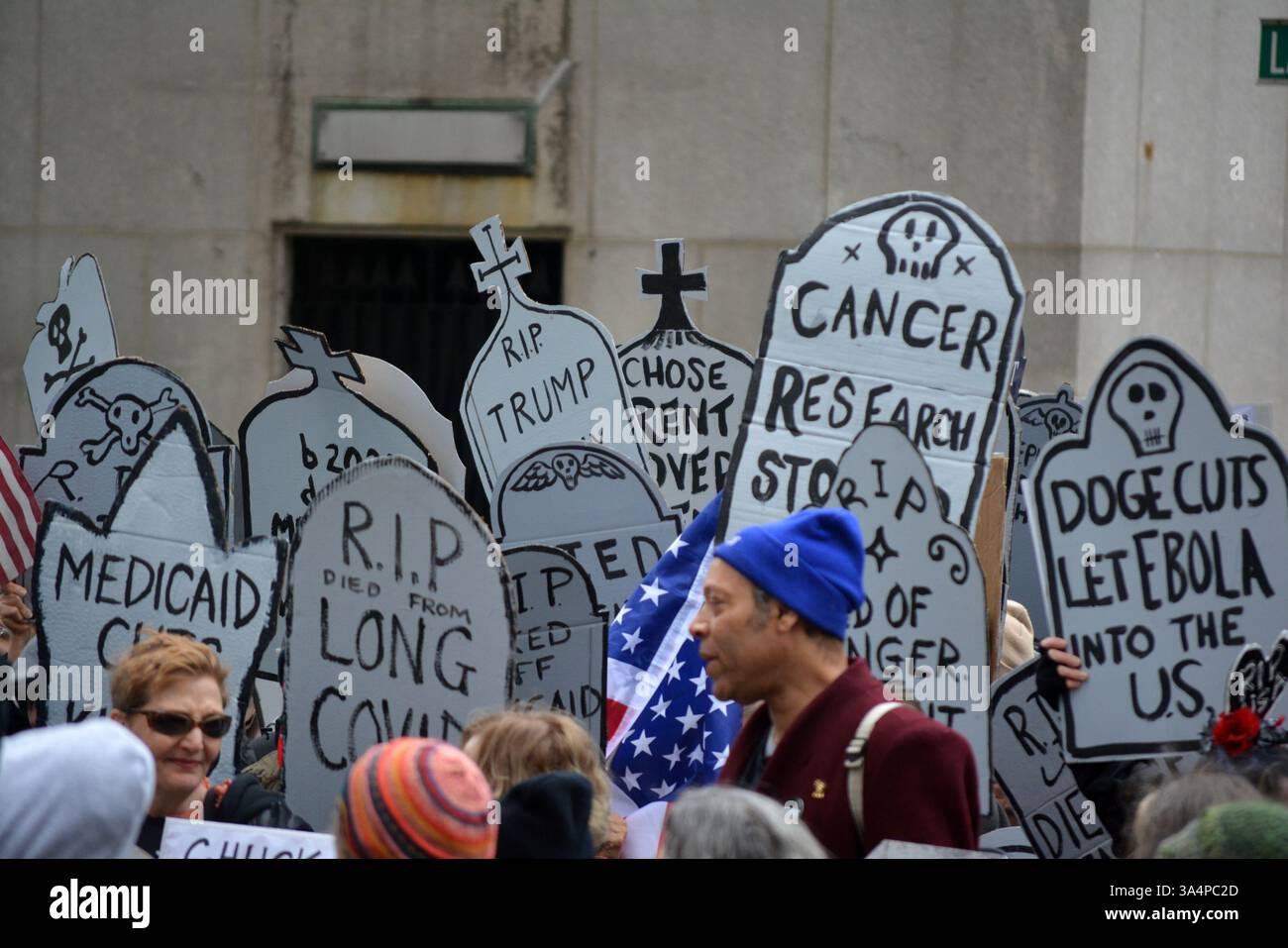 Protesters with fake tombstones at a Stop the Cuts rally against DOGE ...
