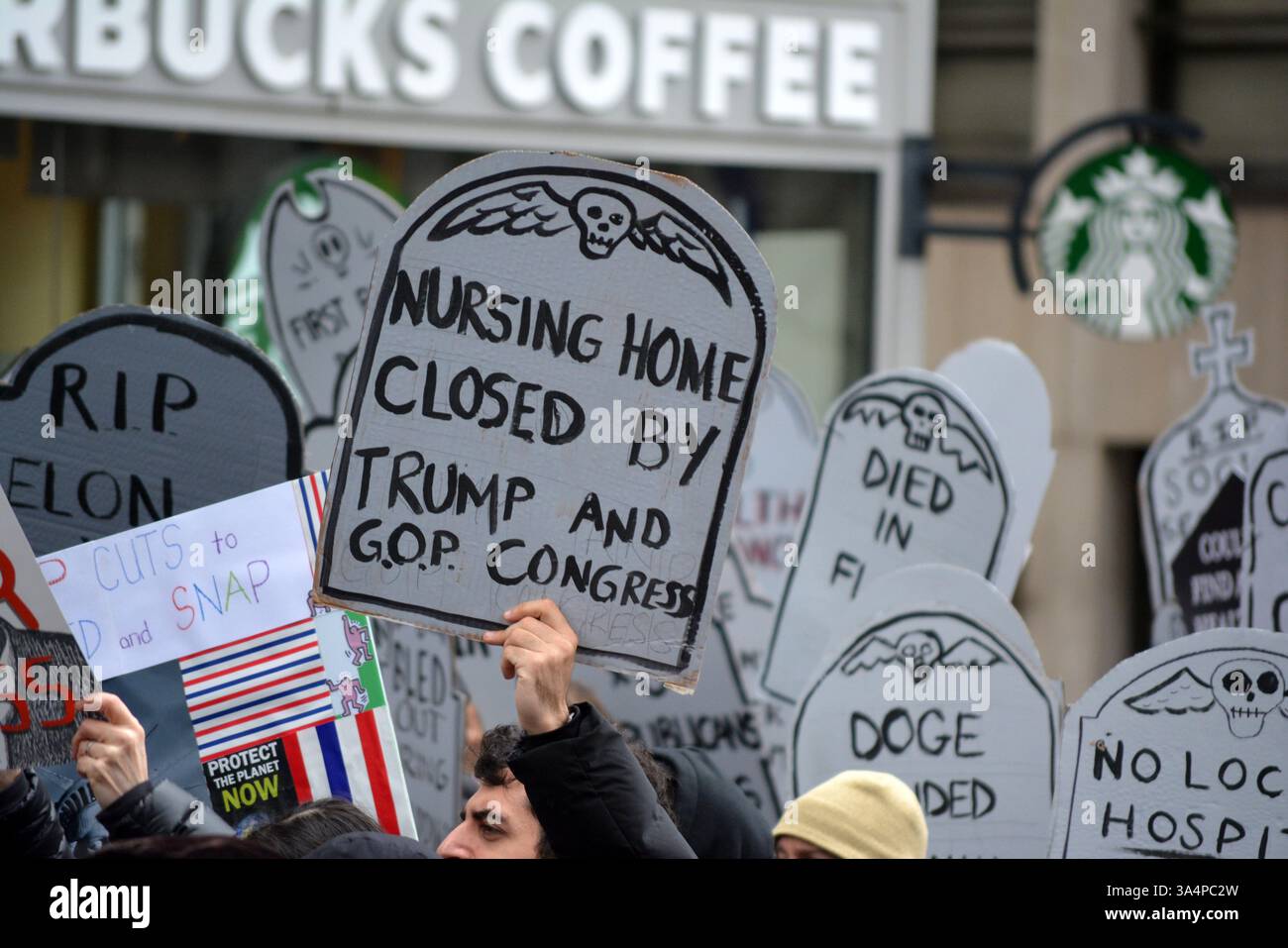 Protesters with fake tombstones at a Stop the Cuts rally against DOGE ...