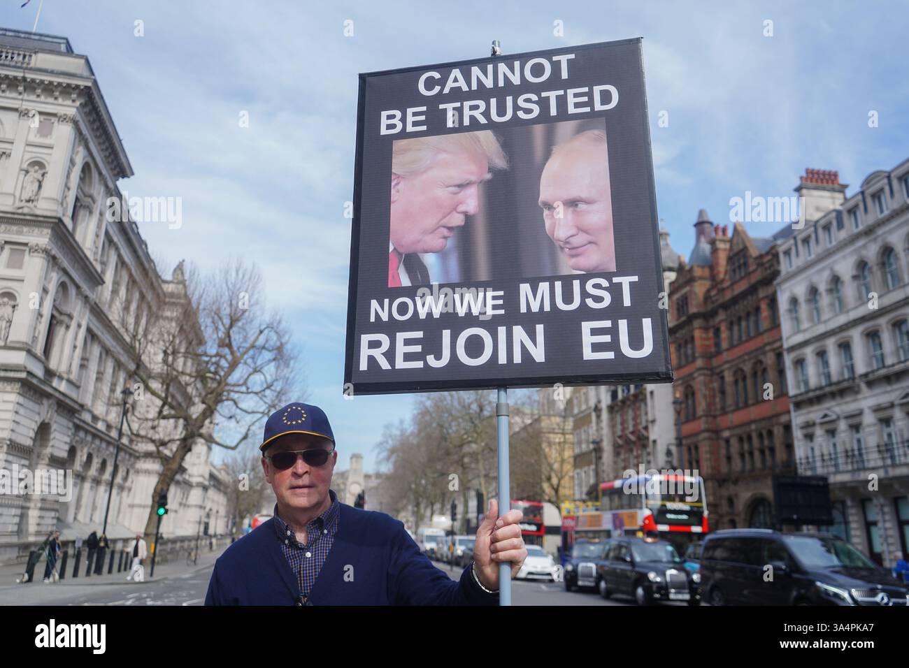 London, UK 19 March 2025. A protester holds a sign in Whitehall with ...