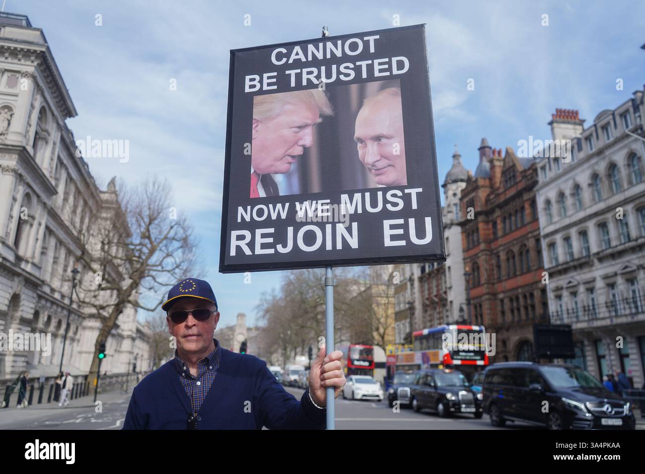 London, UK 19 March 2025. A protester holds a sign in Whitehall with ...